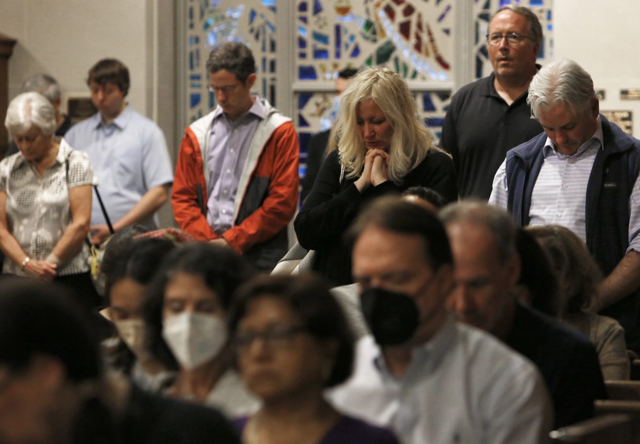 Hundreds comfort one another, grieve together at Mass after shooting